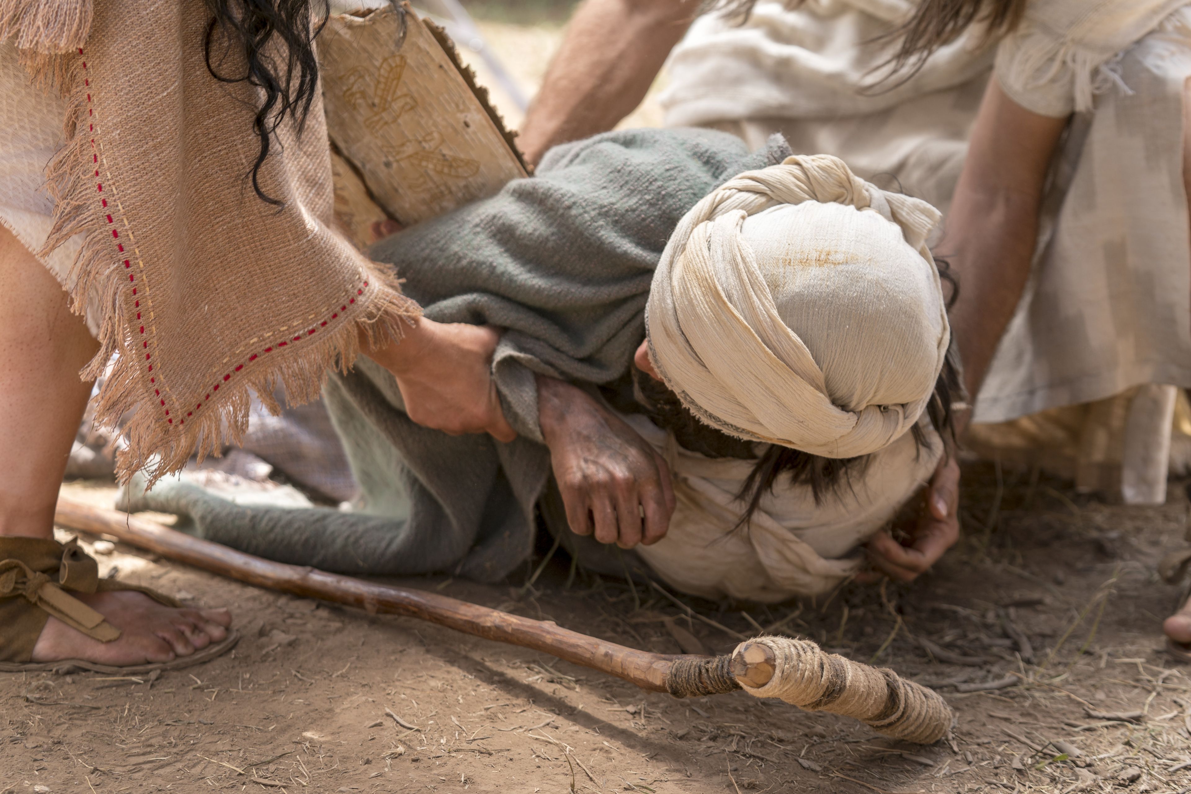 Jacob and his wife helping a crippled man